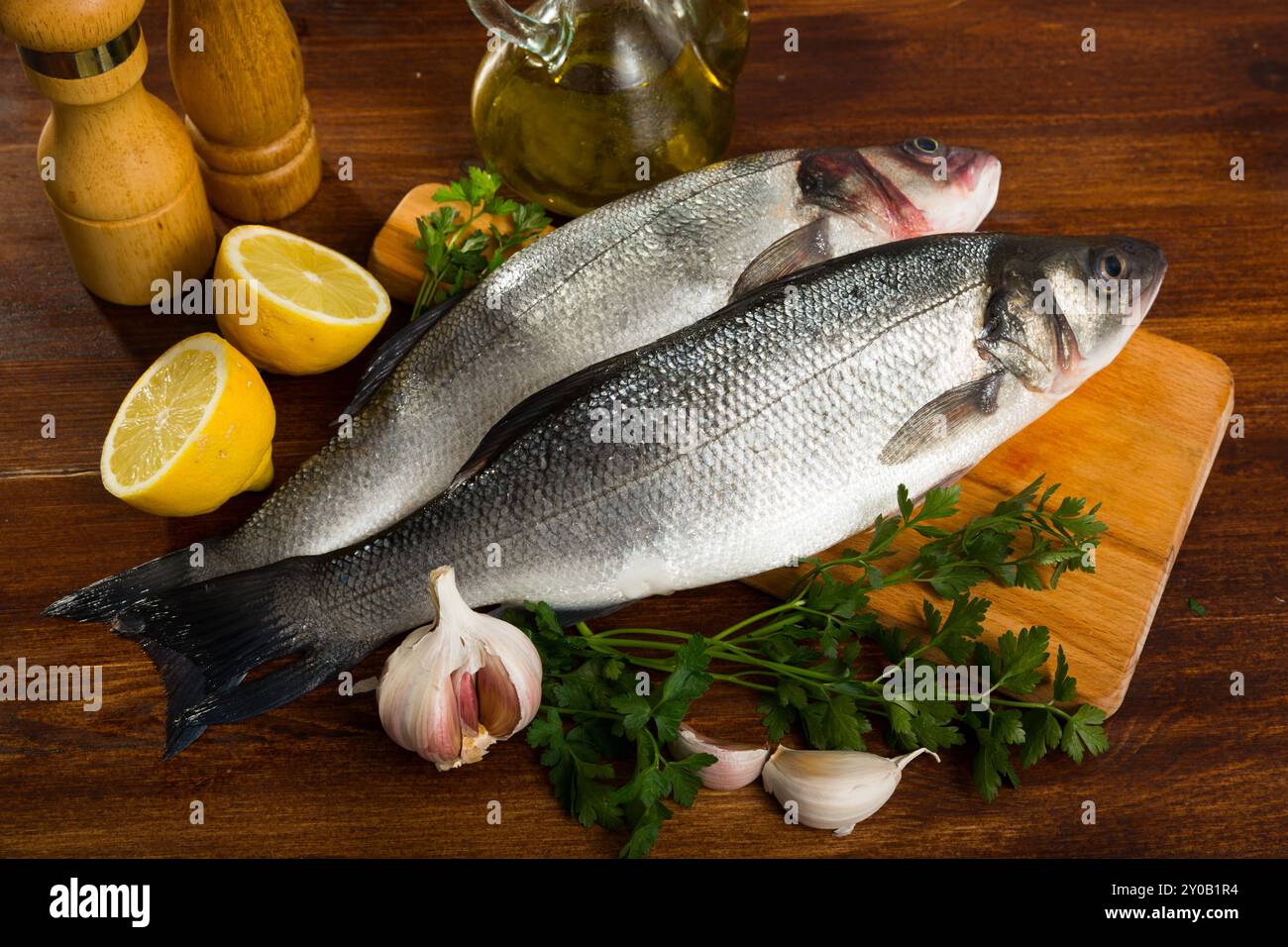 Two raw sea bass fish Stock Photo - Alamy