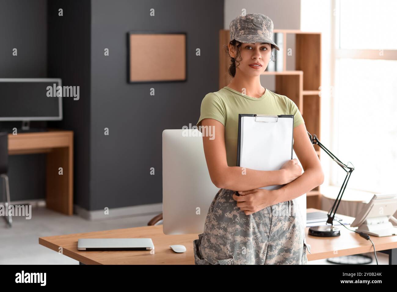 Portrait of female African-American soldier with clipboard at ...