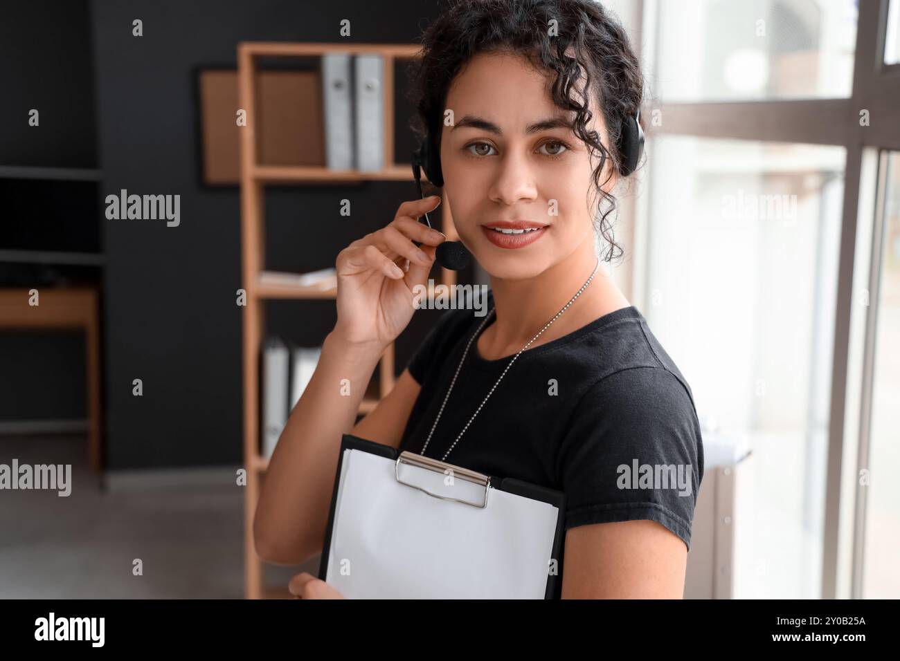 Female African-American soldier in headset with clipboard at ...