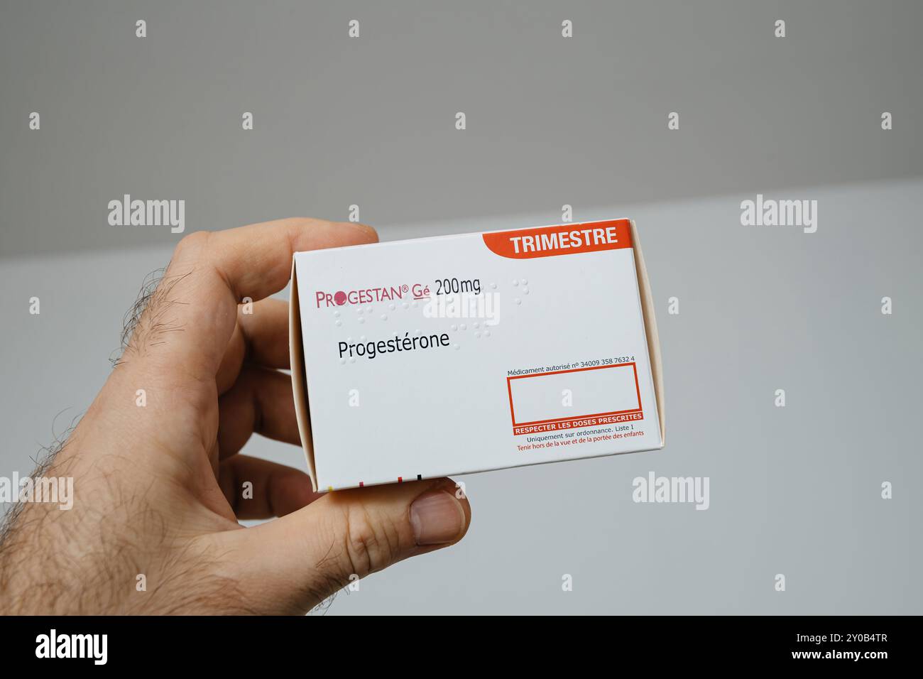 Frankfurt, Germany - Jun 30, 2024: A male hand holding a Progestan GE ...