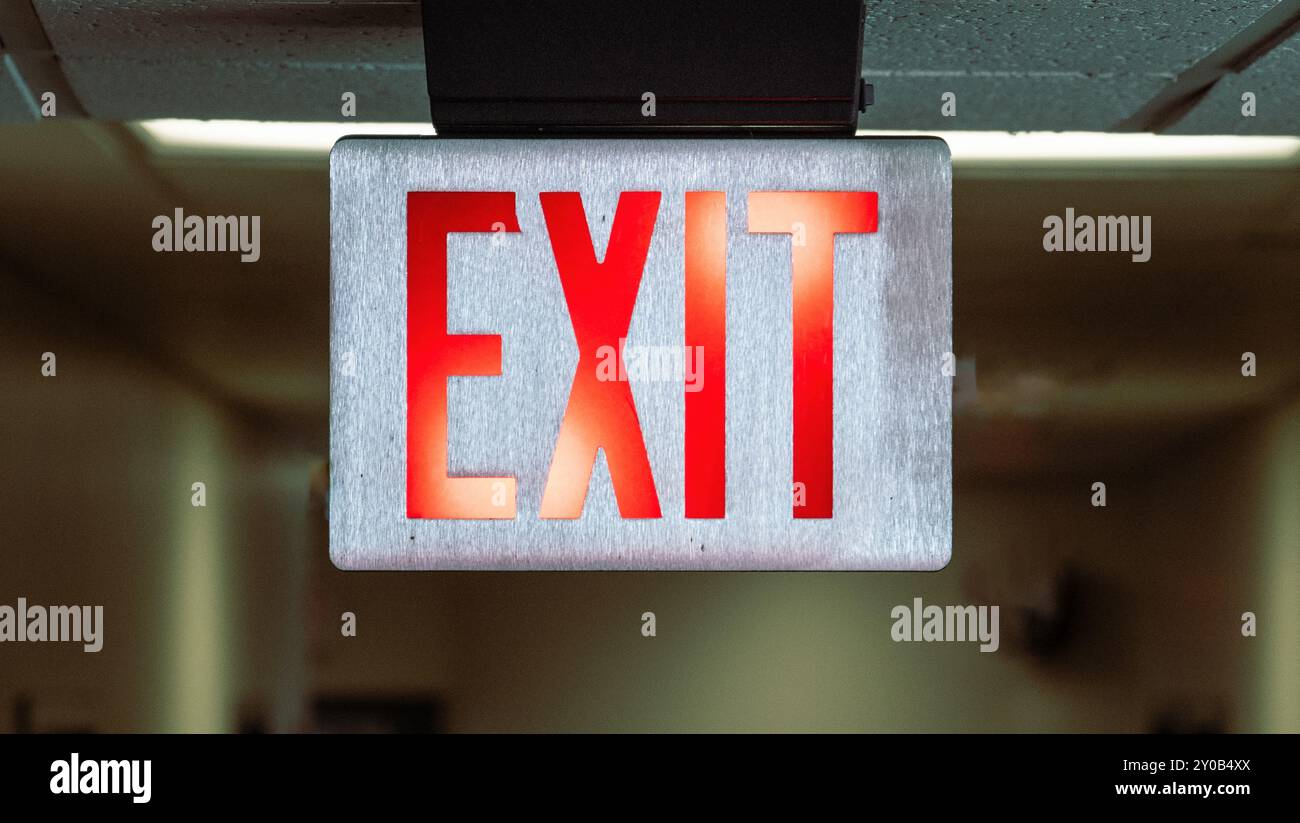 Lighted emergency exit sign hanging from ceiling Stock Photo - Alamy