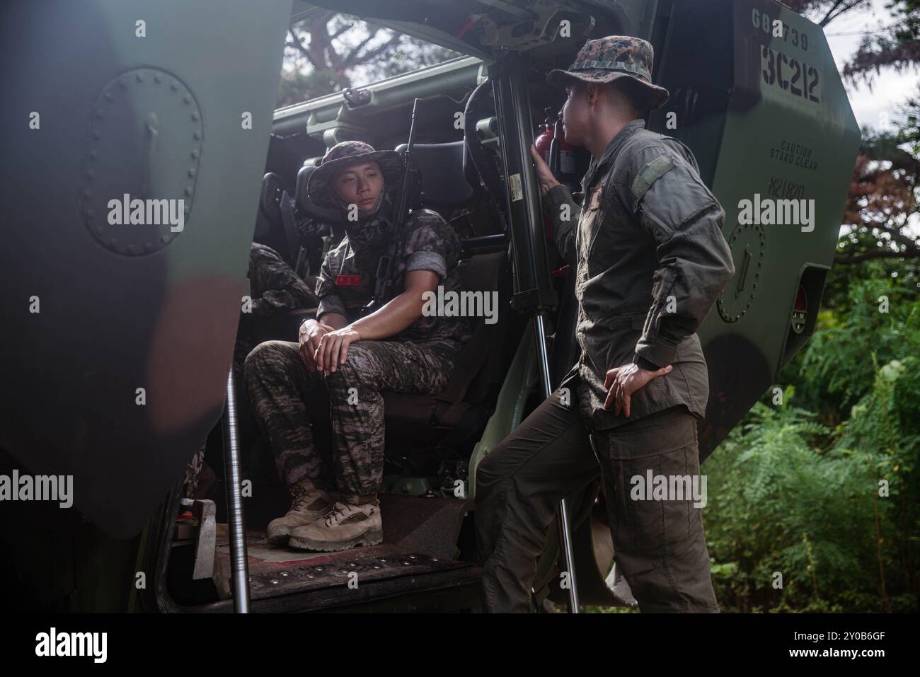 Republic of Korea (ROK) Marine Corps Lance Cpl. Cho Chominjae, left ...