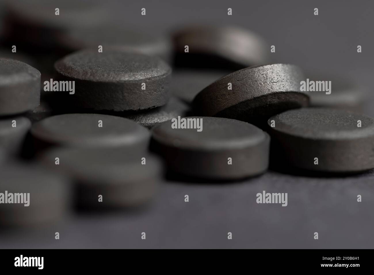 Open and unpacked tablets of black color close-up, a large number of ...