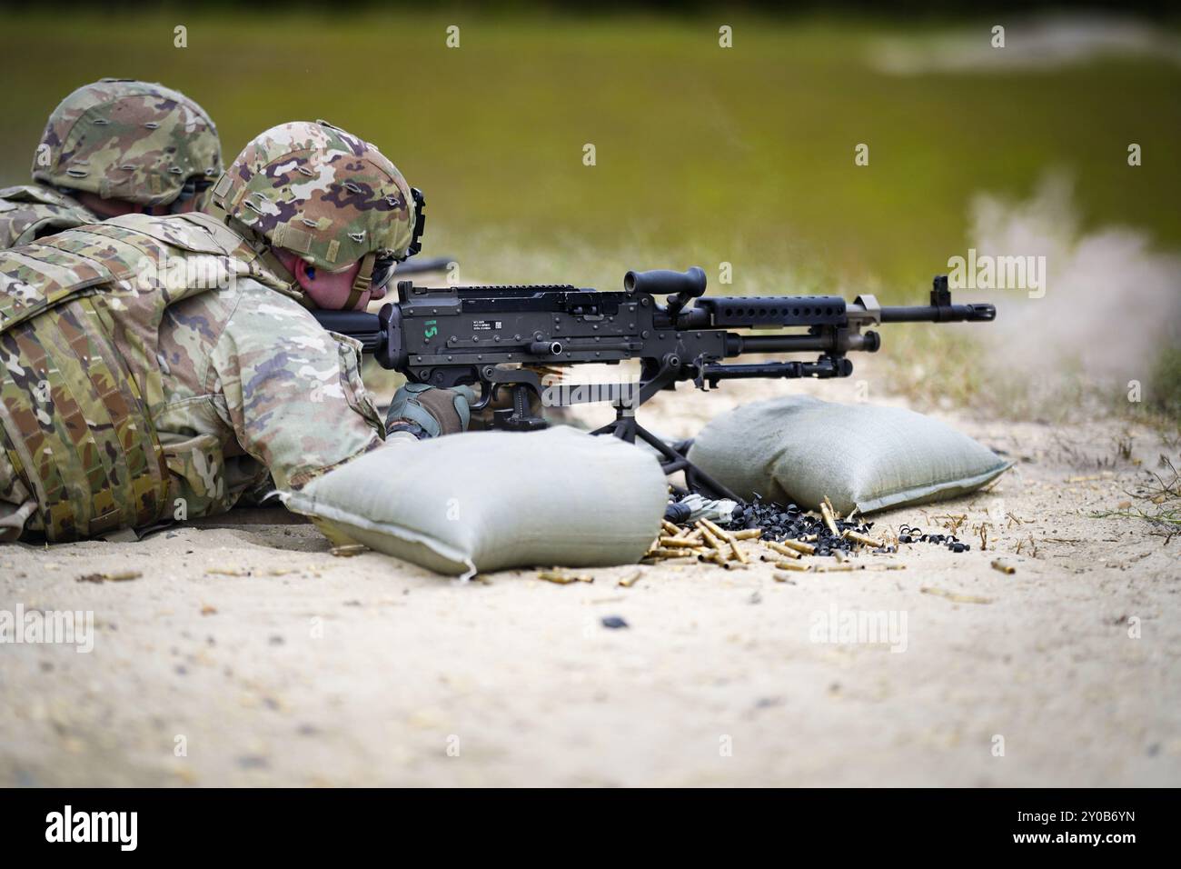 An Army Reserve Best Squad competitor fires an M240B machine gun during ...