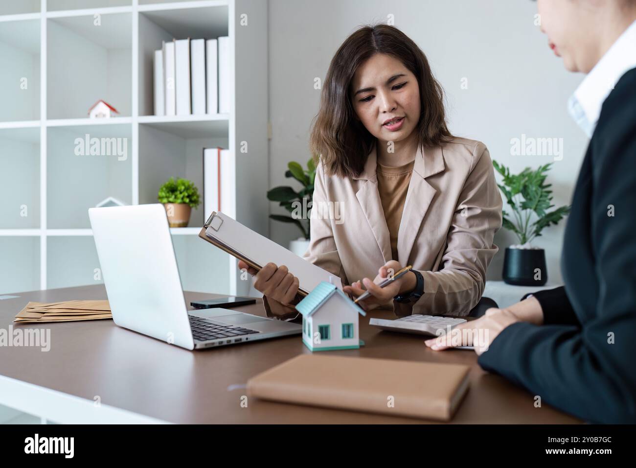 Professional Real Estate Agent Discussing Property Details with Client ...