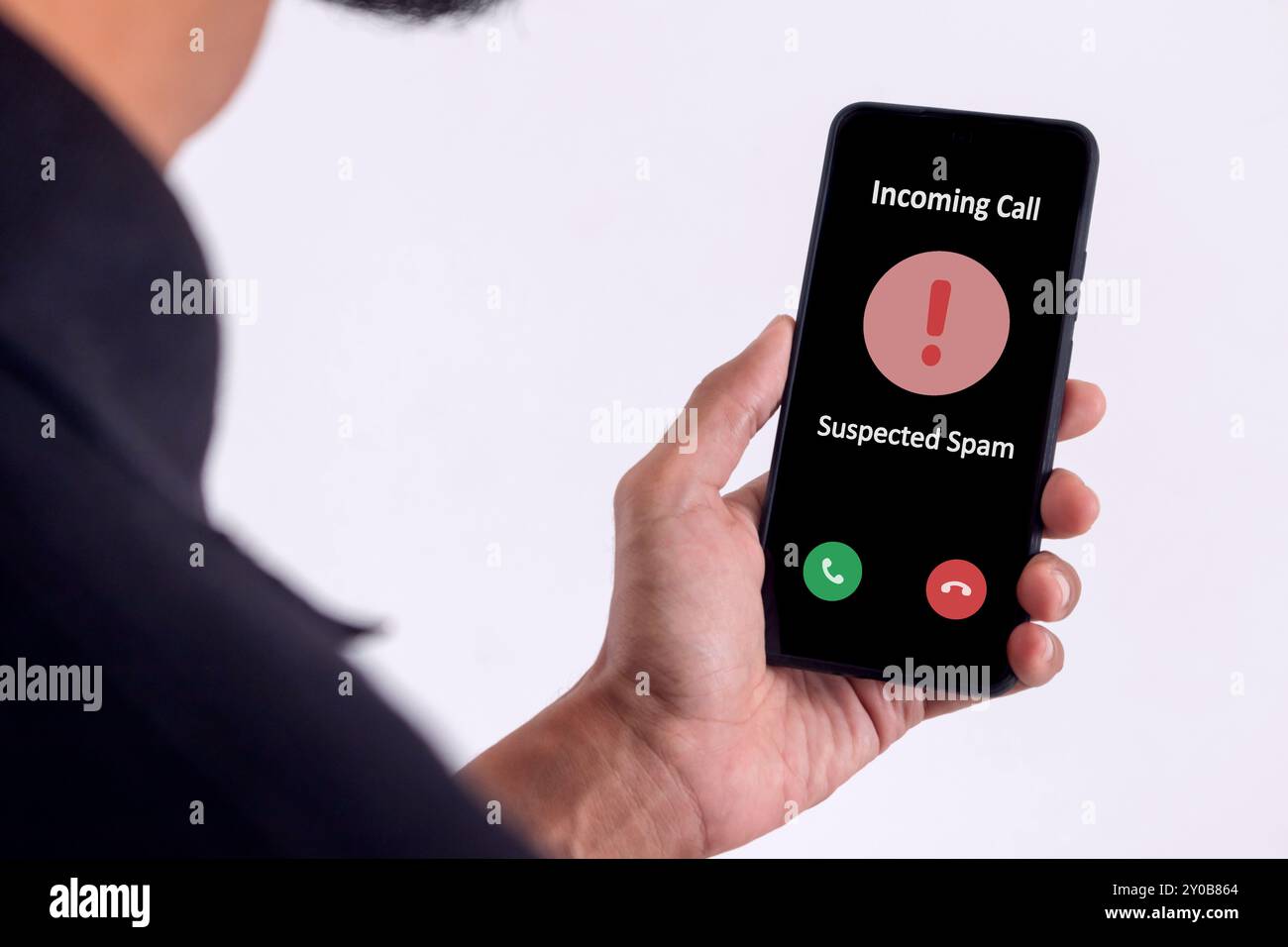 Hand holding a smartphone with incoming call from unknown caller on the ...