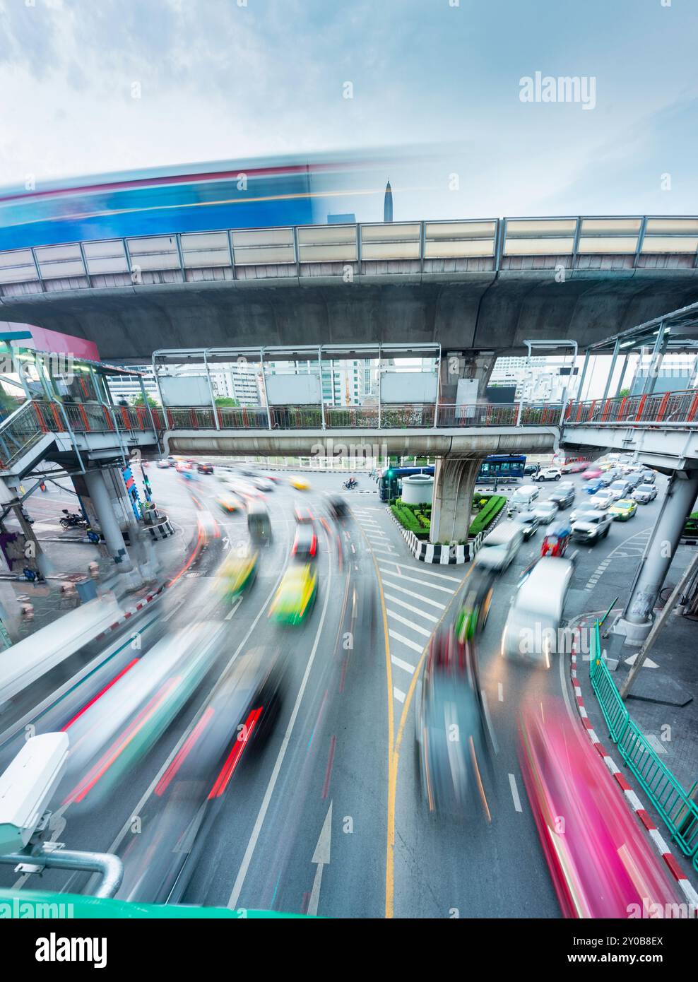 Blurred movement of busy city traffic,rushing under a pedestrian ...