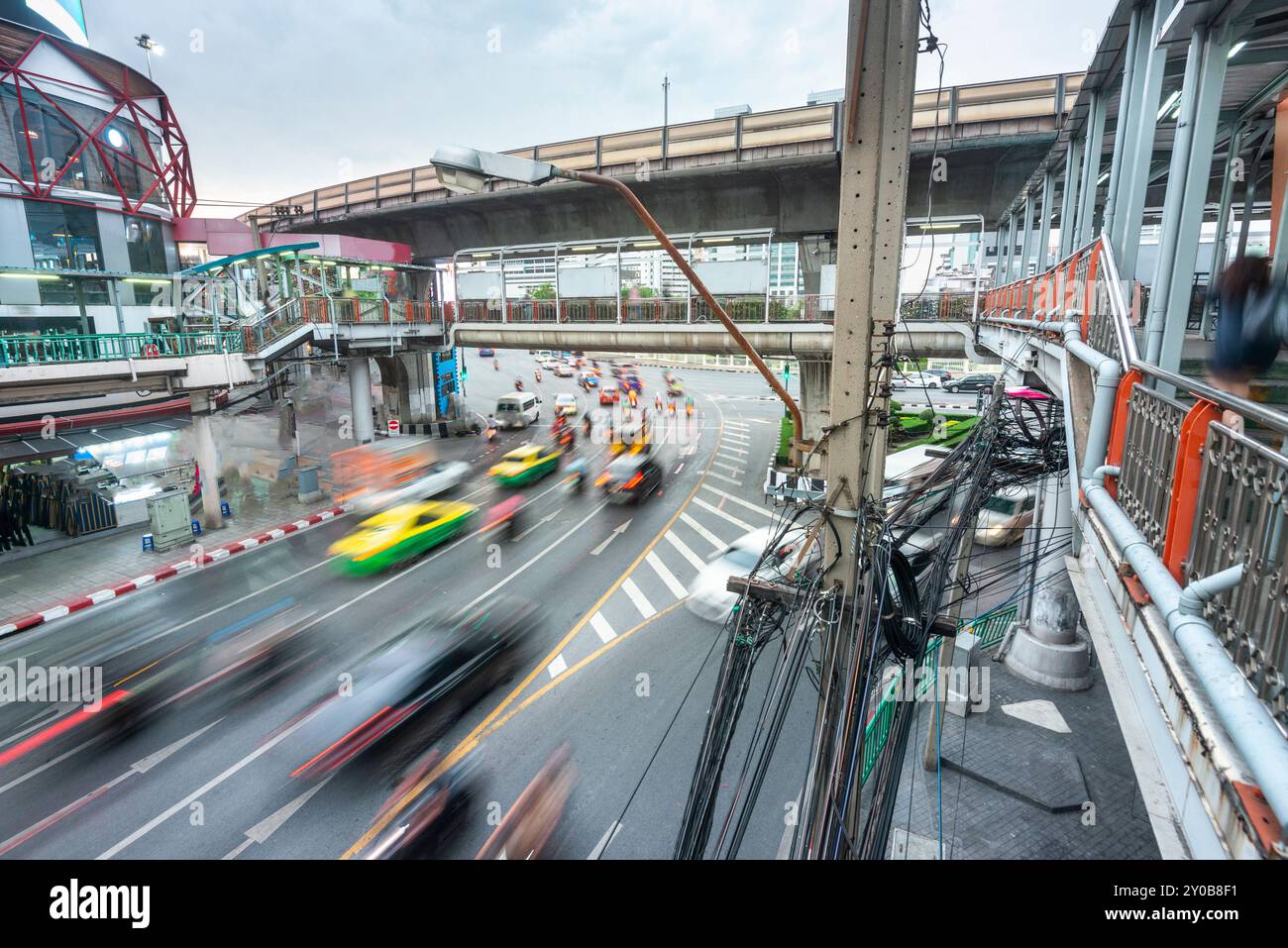 Blurred movement of busy city traffic,rushing under a pedestrian ...