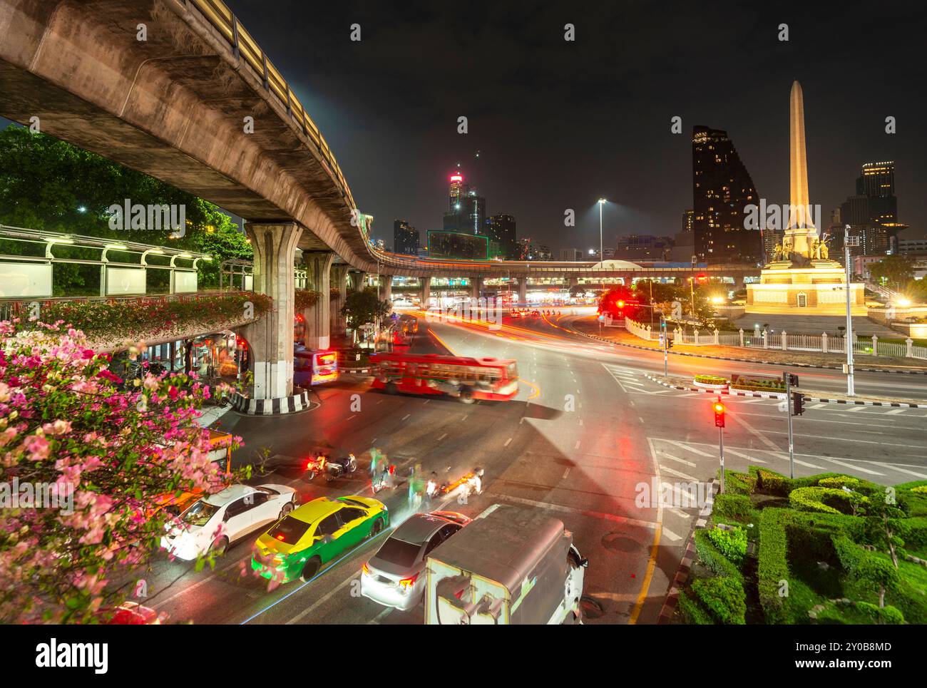 Traffic waiting at a busy junction and many vehicles rush under huge ...