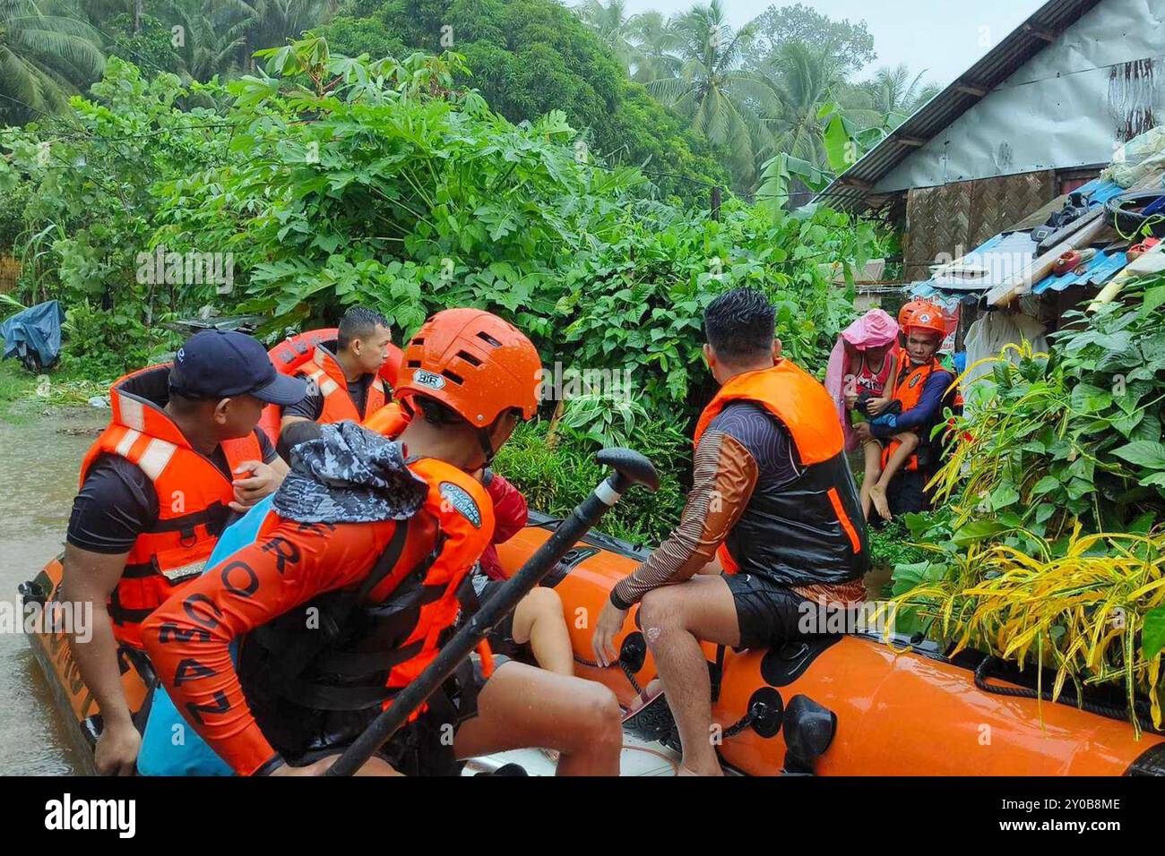 In this photo provided by the Philippine Coast Guard, rescuers use a rubber boat as they ...