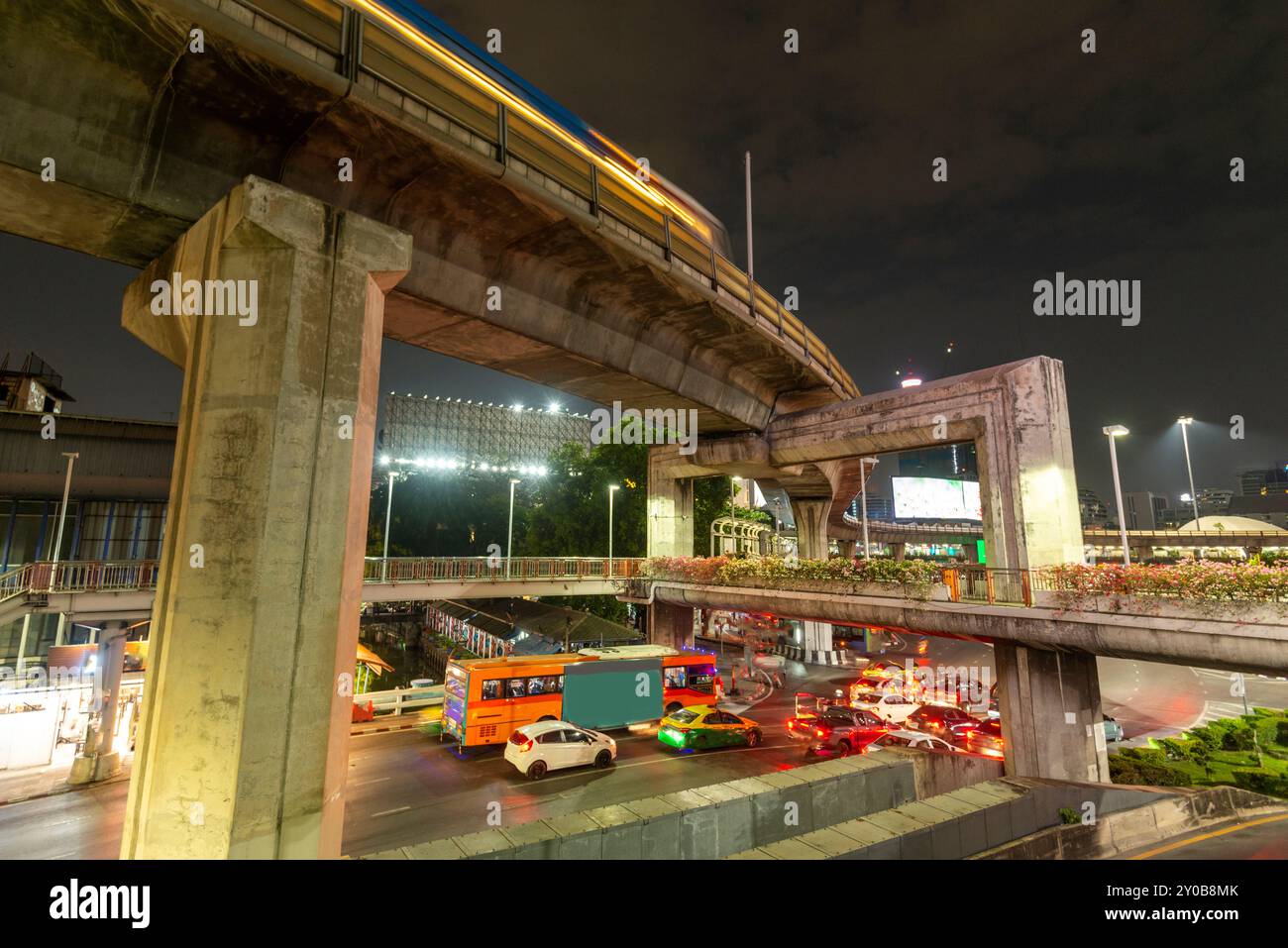 Traffic waiting at a busy junction and many vehicles rush under huge ...