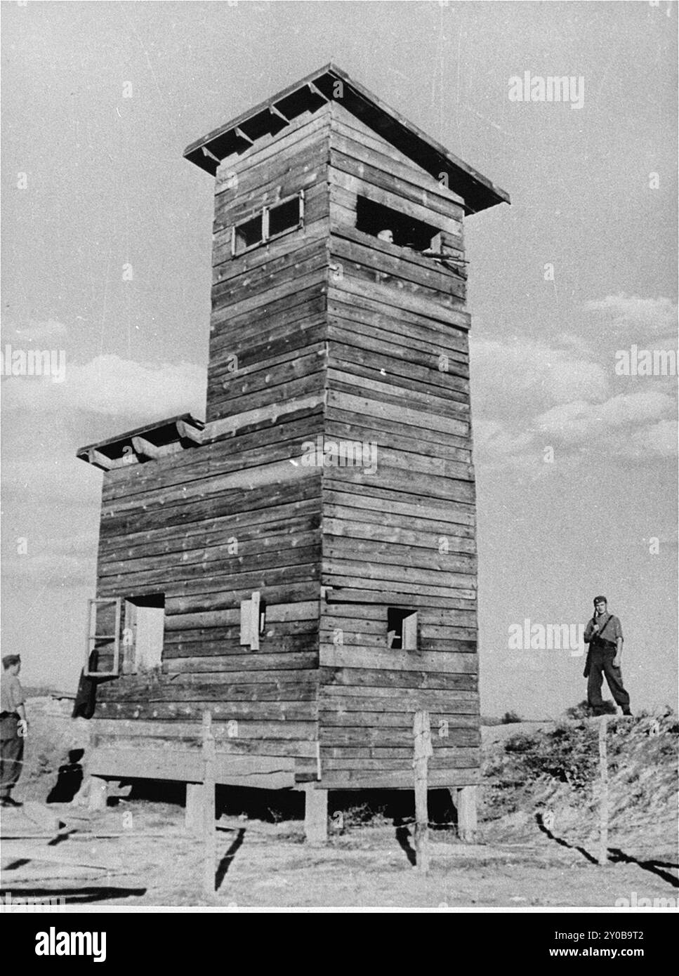 An Ustase guard stands next to a watch tower in the Jasenovac ...