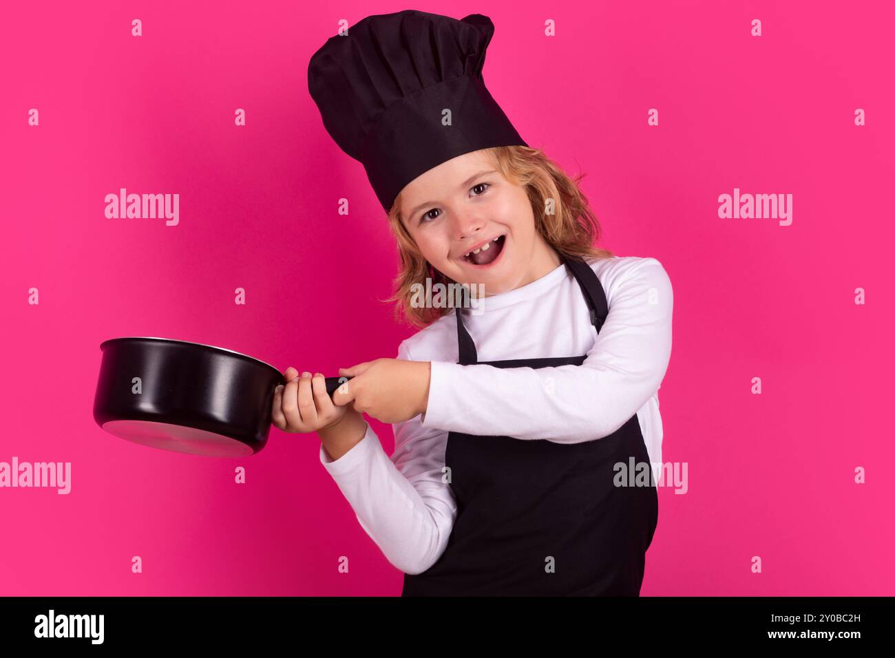 Kid chef cook with cooking pot. Excited chef cook. Child wearing cooker ...