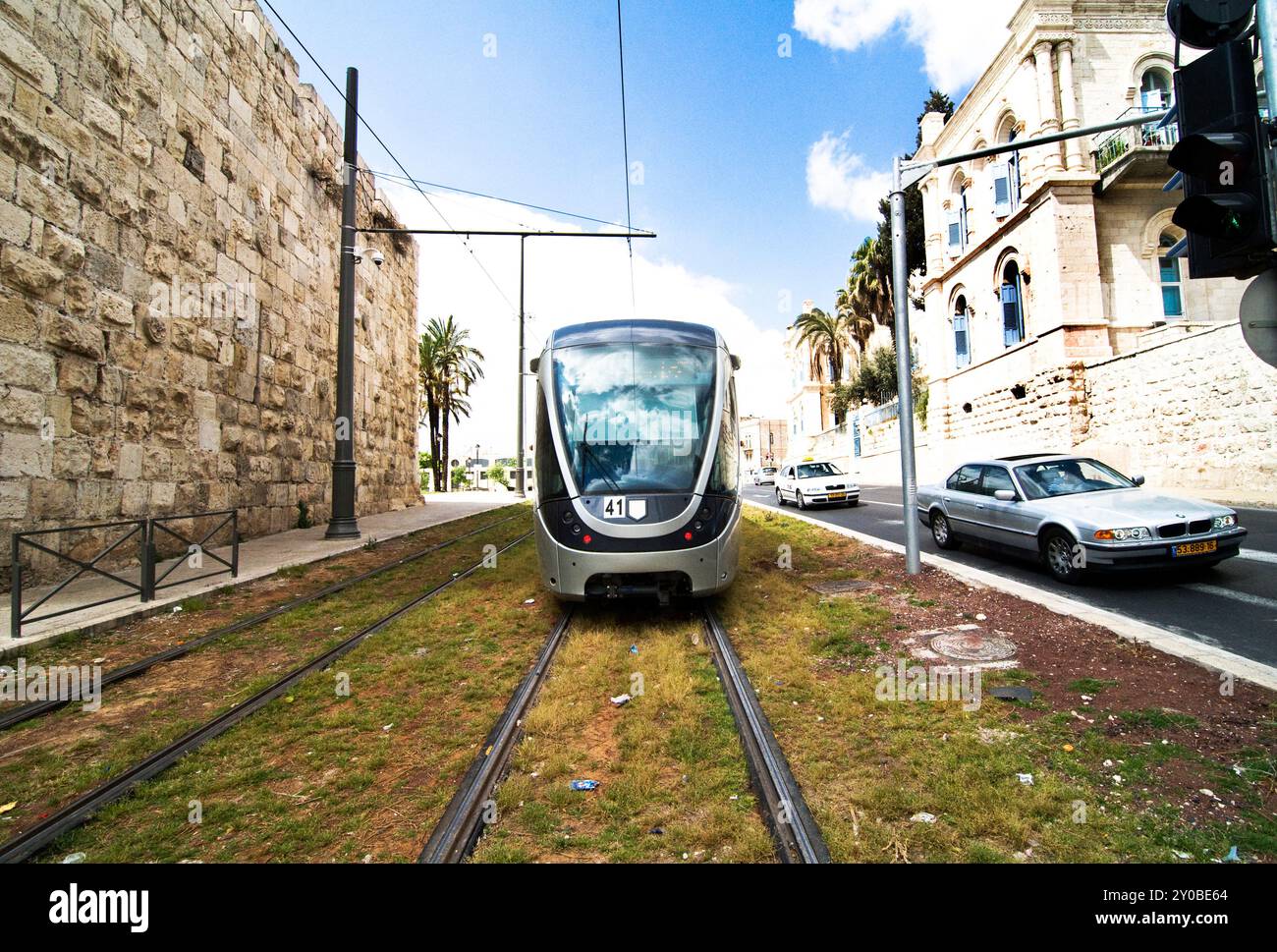 The tram by the old city wall along Stock Photo - Alamy