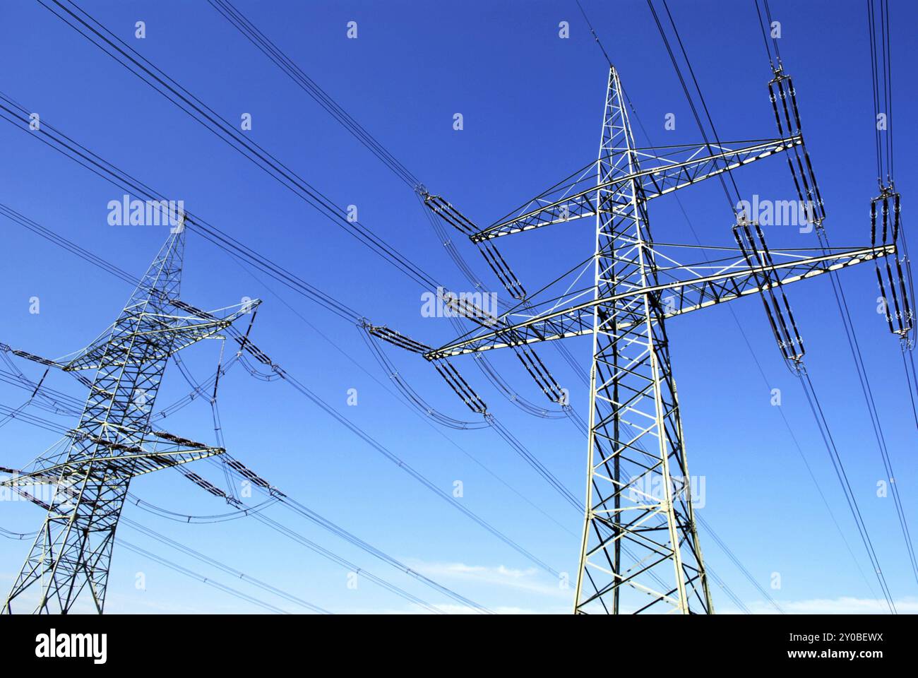 Two pylons in fornt of deep blue sky and some clouds Stock Photo - Alamy