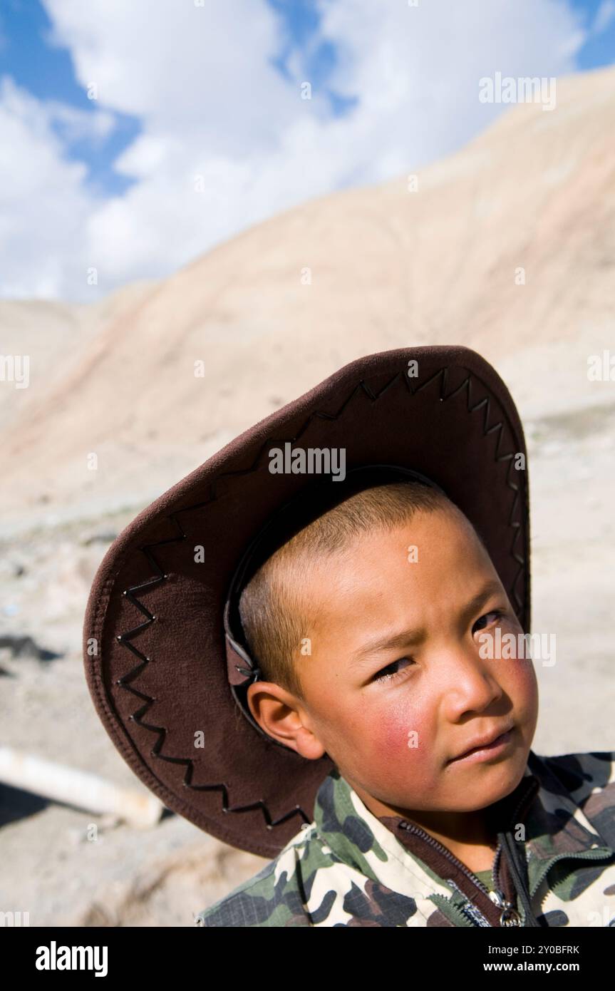 Portrait of a Kyrgyz boy taken at his village by the Karakul lake in ...