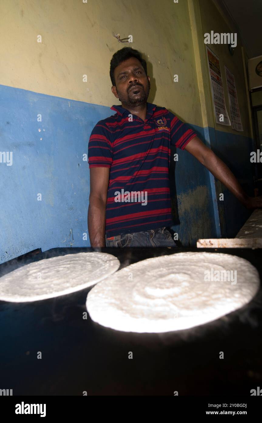 A Tamil man cooking dosa in a small restaruant in Kandy, Sri Lanka ...