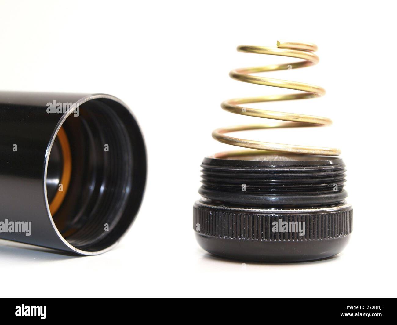 Flashlight bottom with the battery capsule out, spring showing, and ...