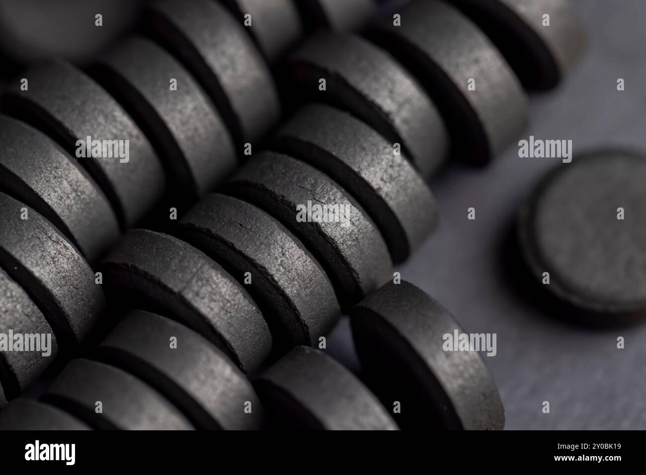 Open and unpacked tablets of black color close-up, a large number of ...