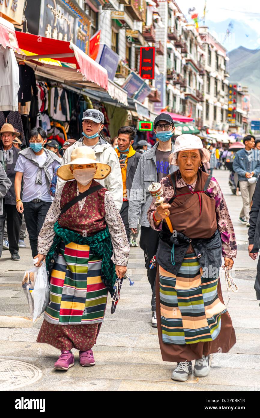 LHASA CHINA - JULY 5, 2022: Two generations of tibetan woman walk at ...