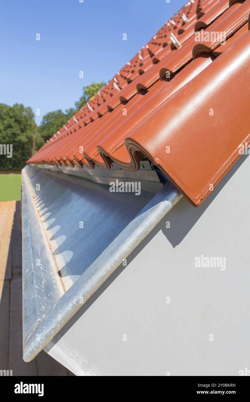 Close up rain gutter with roof tiles at new house Stock Photo - Alamy