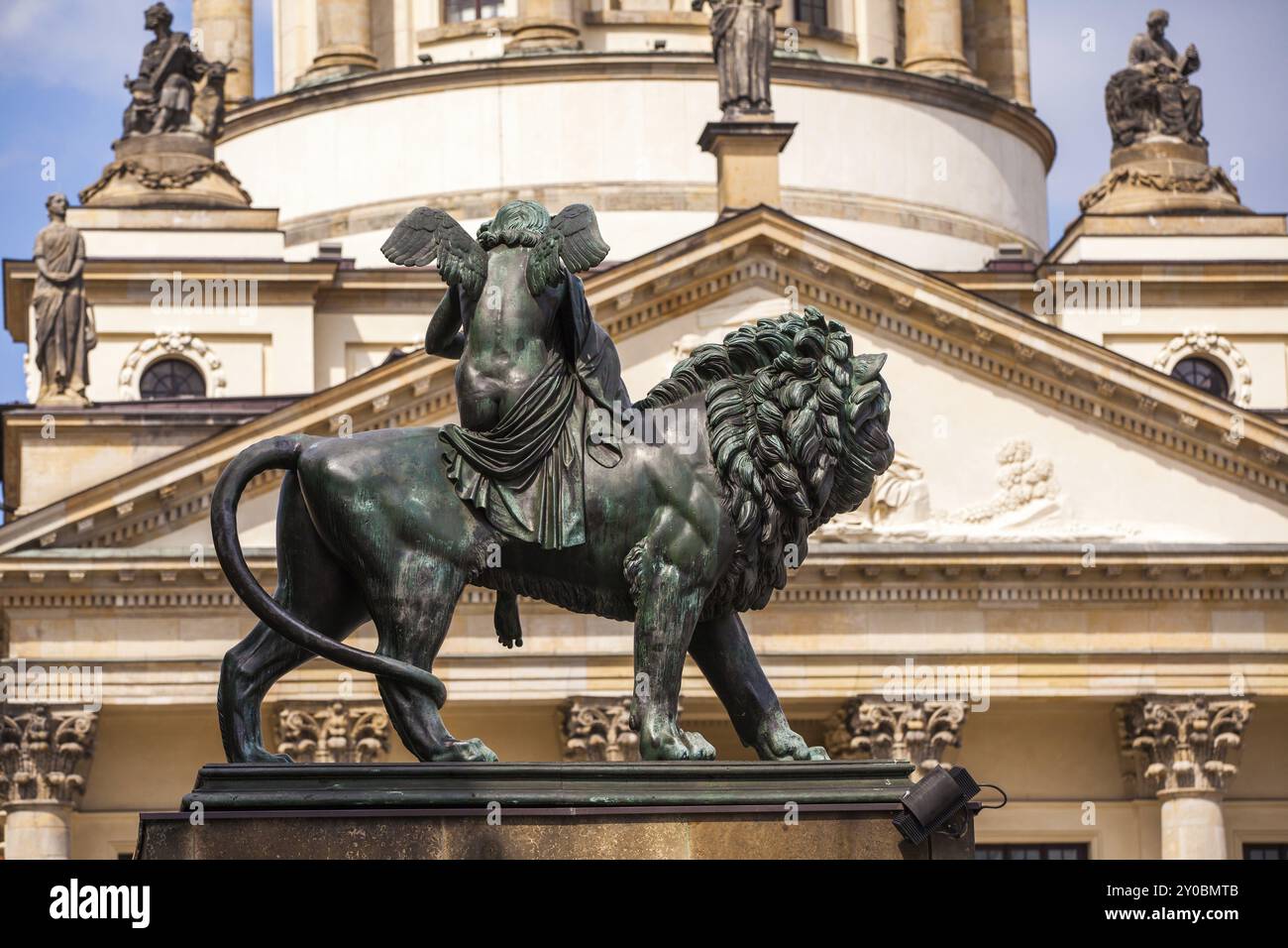 Statue of an angel riding a lion and playing the harp, with the French ...
