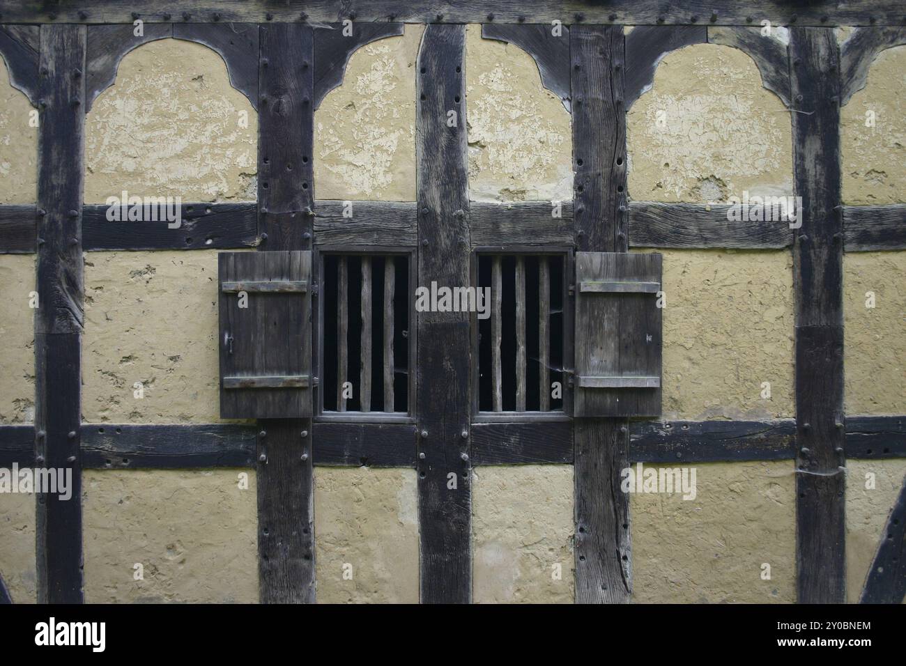 Half-timbered wall with barred window Stock Photo - Alamy
