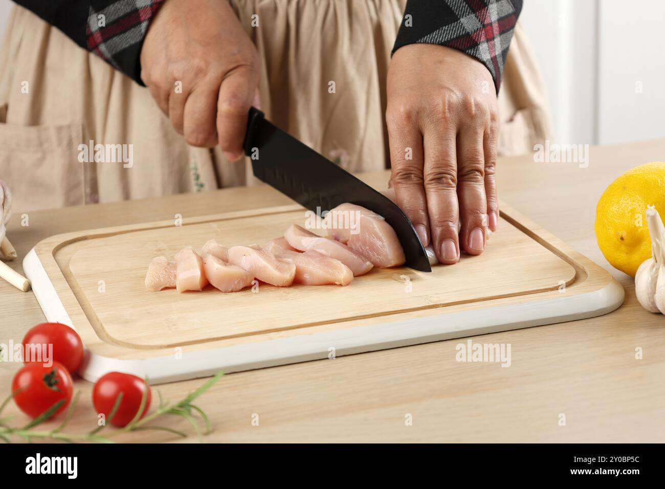 Female Hand Slicing Cut Chicken Fillet on Bamboo Chopping Board ...