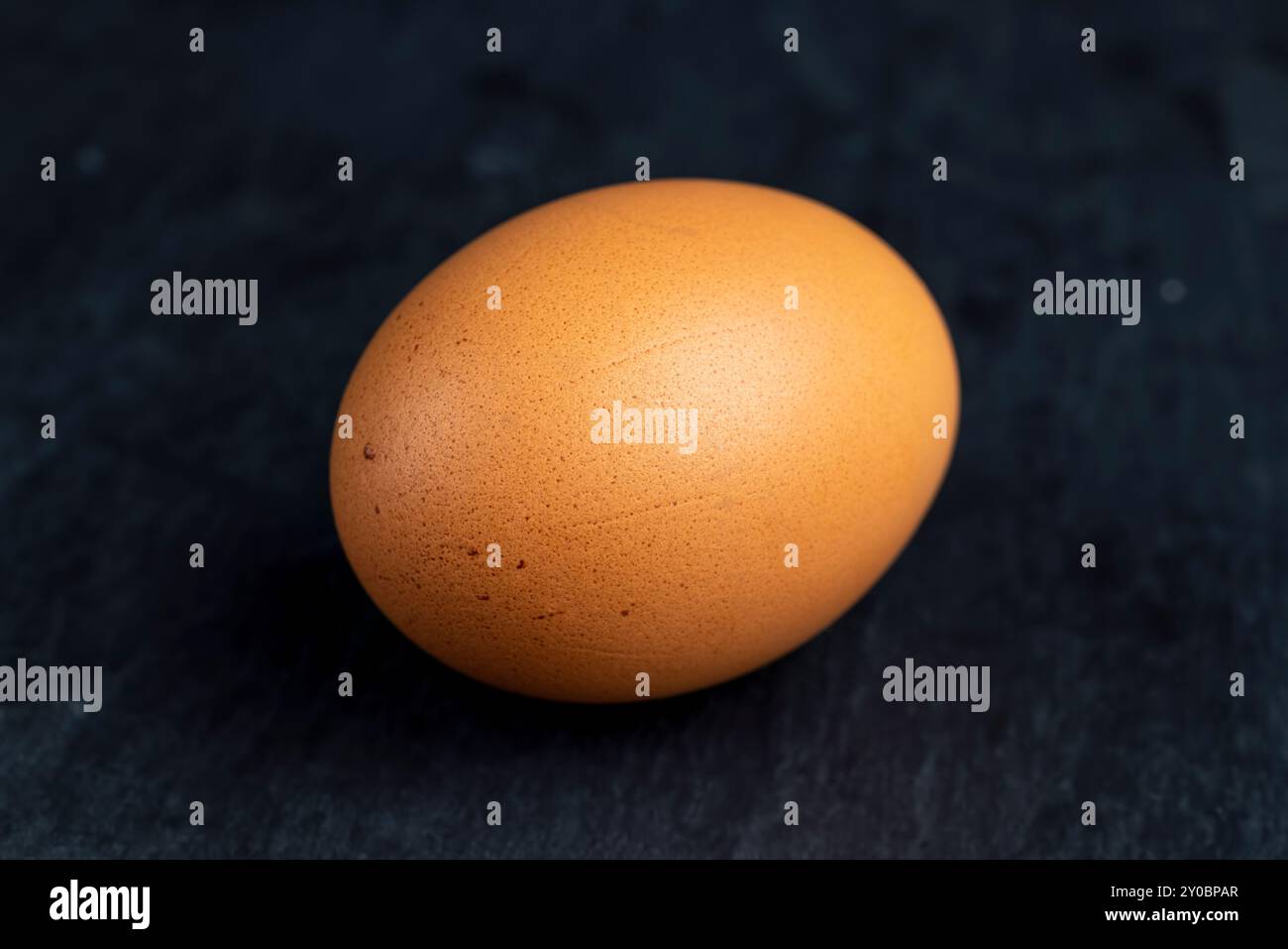 A whole orange chicken egg close-up on the table, a large chicken egg ...