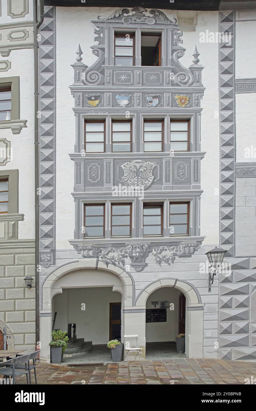 Building with archway and grey illusion painting, ornaments, sgraffiti ...