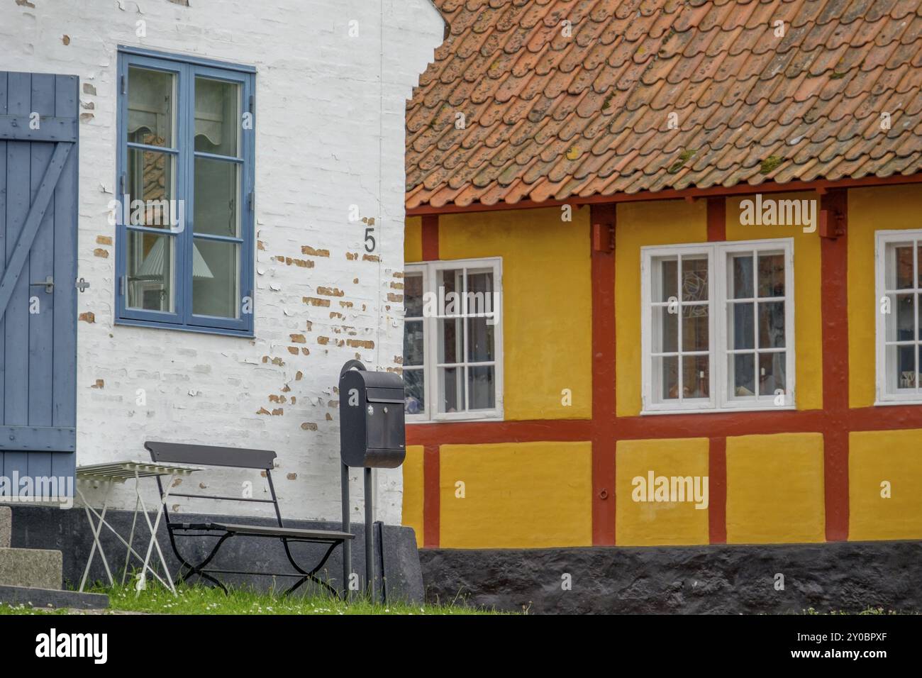 Traditional building with white and yellow brick walls, windows and a ...