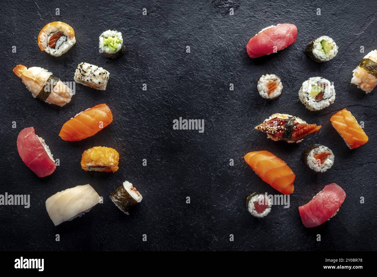 Sushi frame, a flat lay, top shot. Rolls, maki, nigiri on a black slate ...