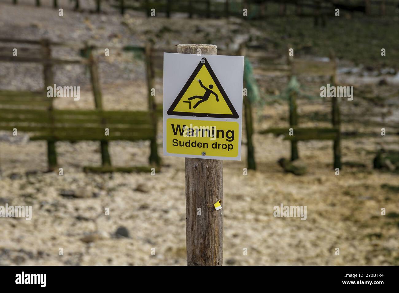 Sign: Warning sudden drop, seen in Cuckmere Haven near Seaford, East ...