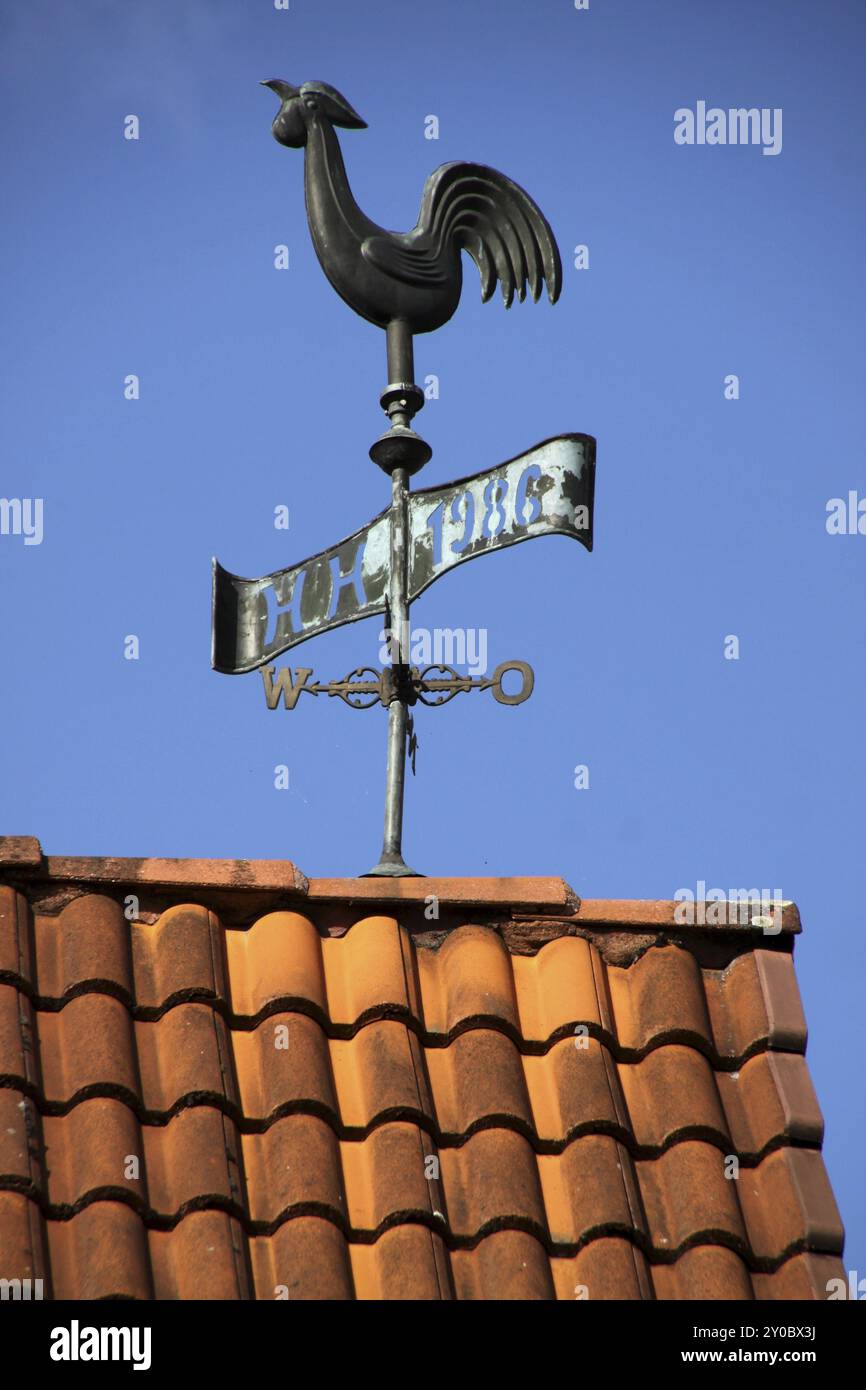 Weathercock on a roof in Luegde Stock Photo - Alamy