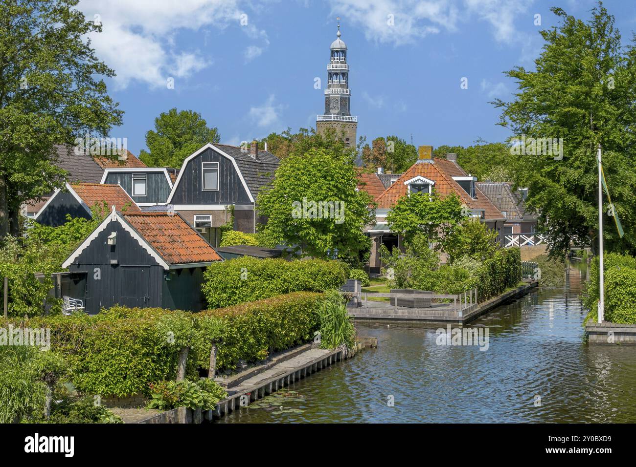 Canals and church tower of the Grote Kerk (Great Church) in Hindeloopen ...