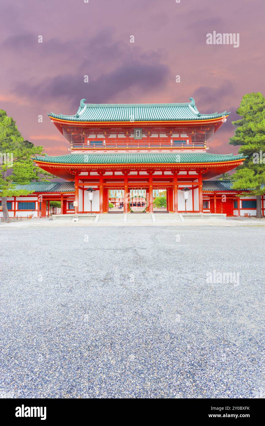 A beautiful sunset sky and centered view of large red front Tower Gate ...
