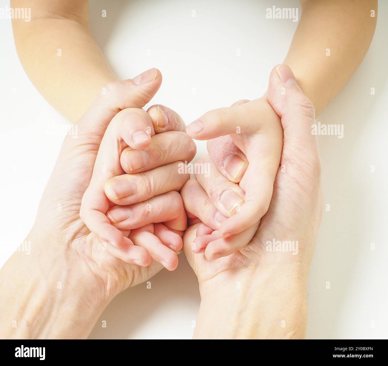 Toddlers hands in fathers hands, towards, on a white table Stock Photo ...