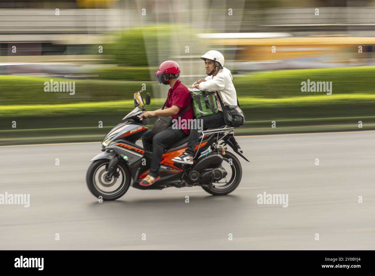 Two men on a moving motorbike, Radchadamnoen Klang Road, Phra Nakhon ...