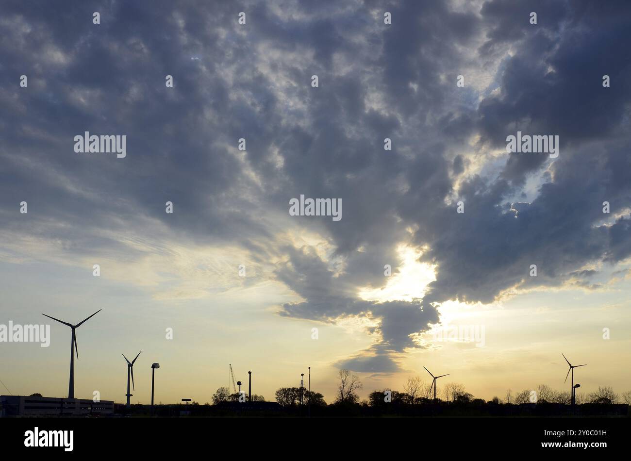 Dramatic sky with wind wheels at horizon Stock Photo - Alamy