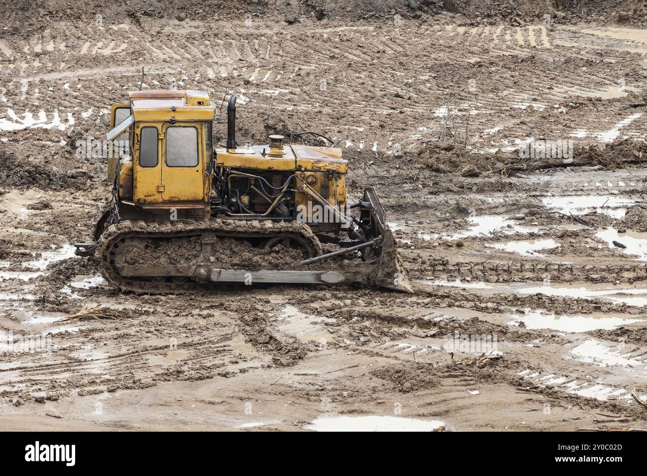 Old rusty earth digging caterpillar bulldozer machine working at ...