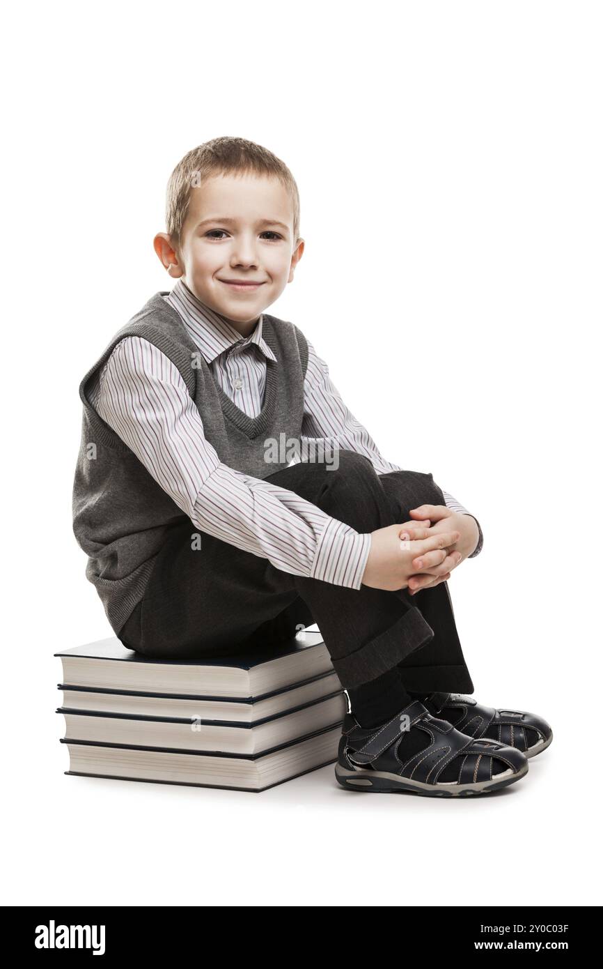 Little smiling child boy sitting on education reading books stack Stock ...
