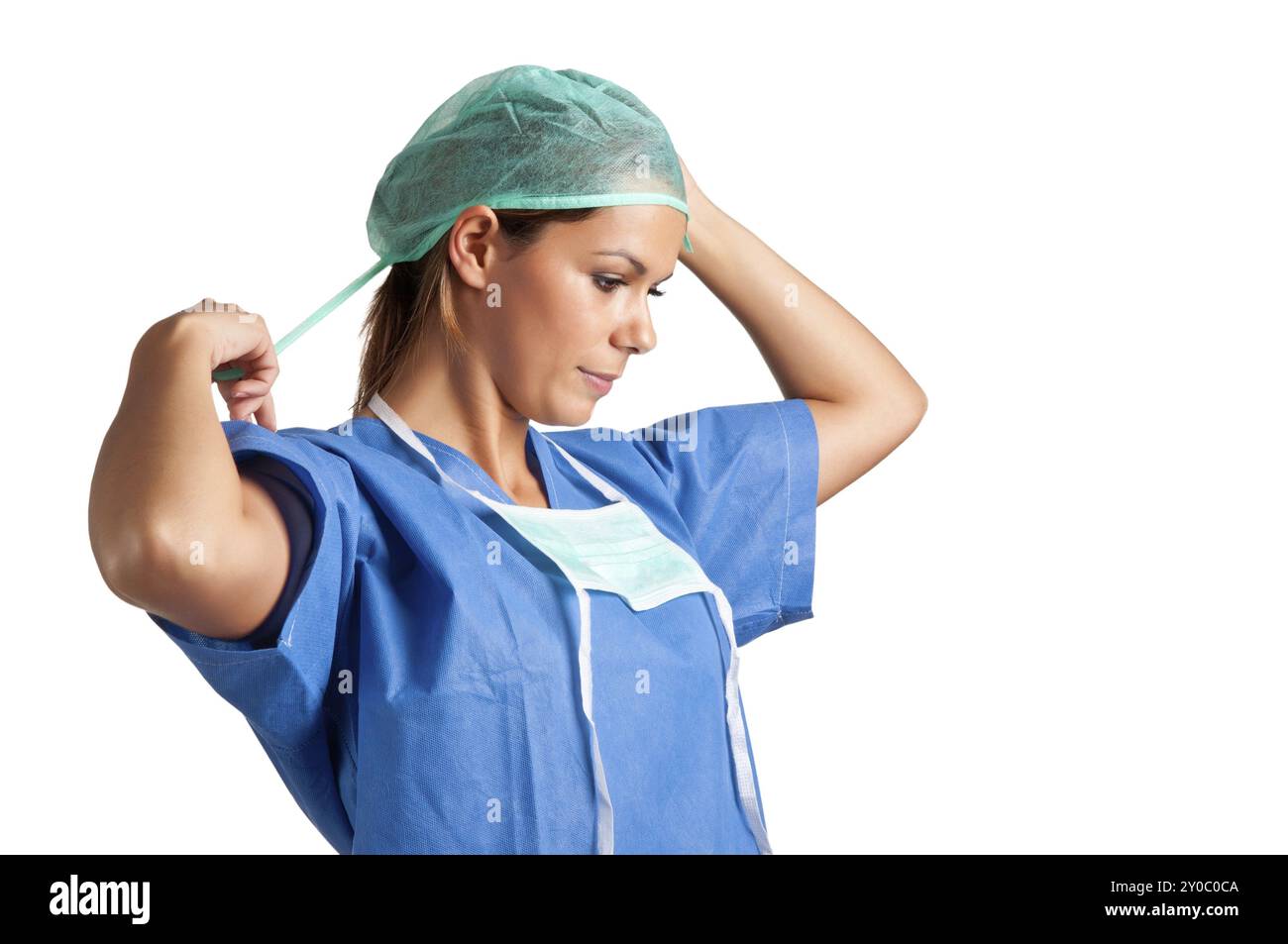 Young female surgeon getting ready for a surgery, isolated in a white ...