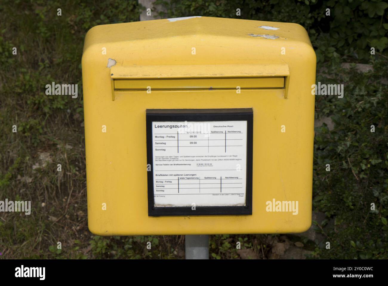 Battered old yellow german letterbox Stock Photo - Alamy