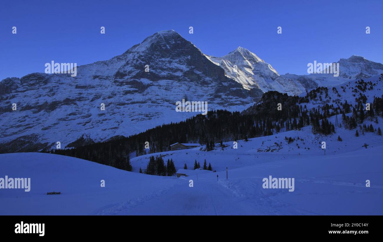 Eiger north face in winter. Famous mountains Eiger, Monch and Jungfrau ...