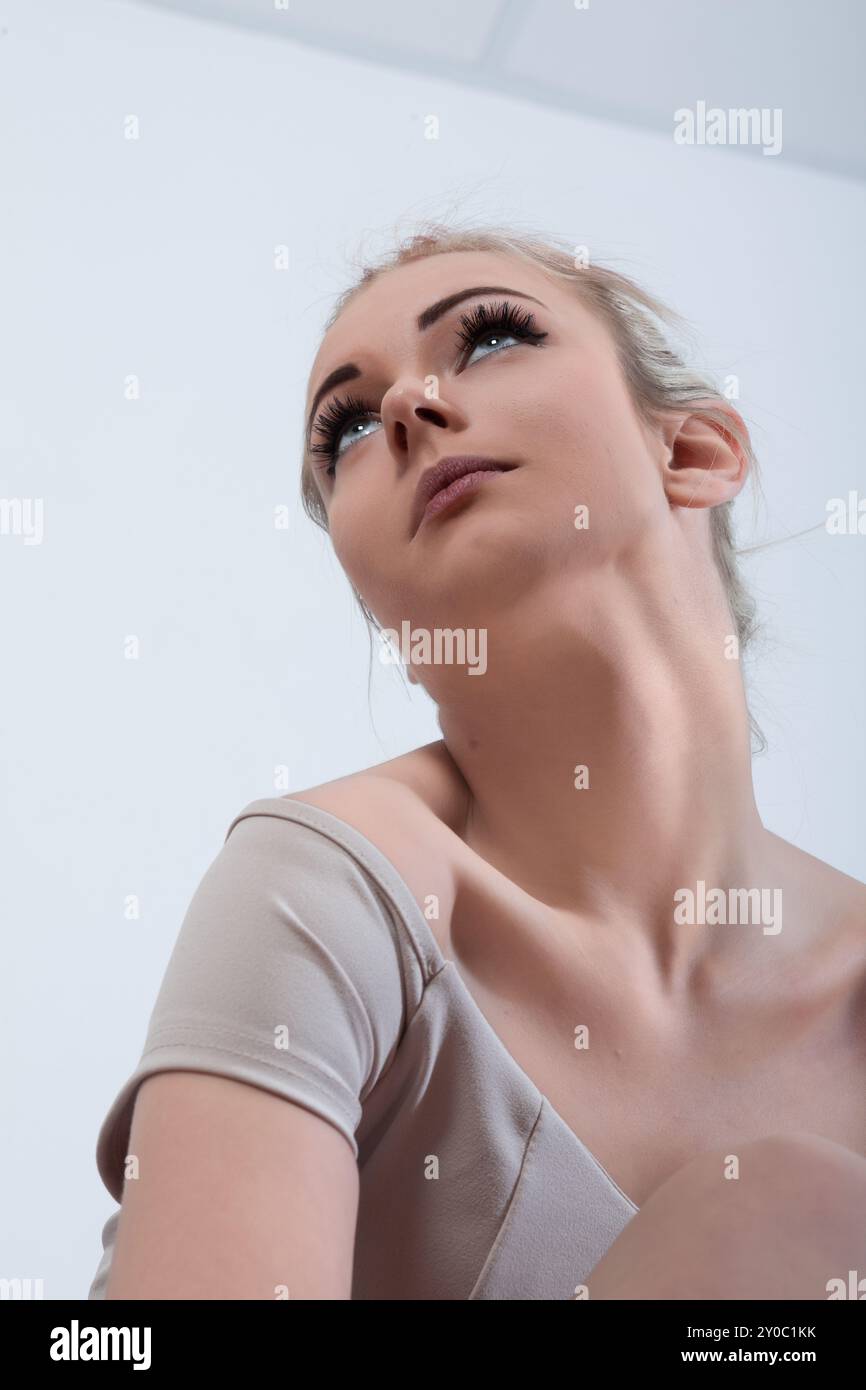 Determined young ballerina stretches in a dance studio, exuding grace ...