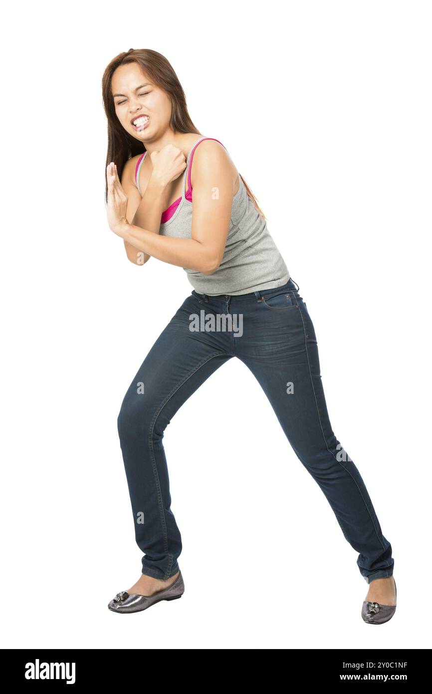 Straining Asian woman casual clothes driving back, fighting away ...