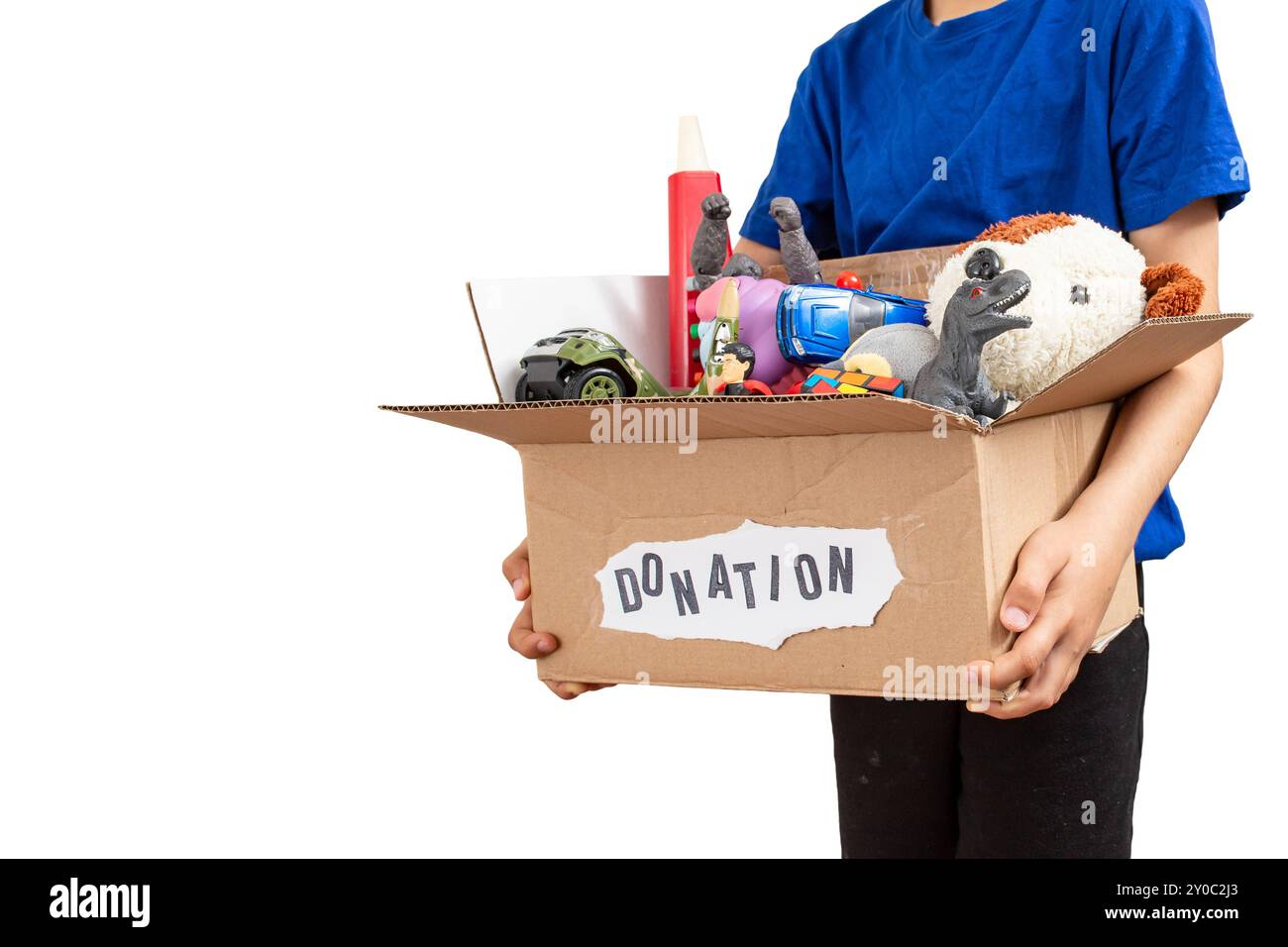 Unrecognizable child hands holding a cardboard box full of child toys ...