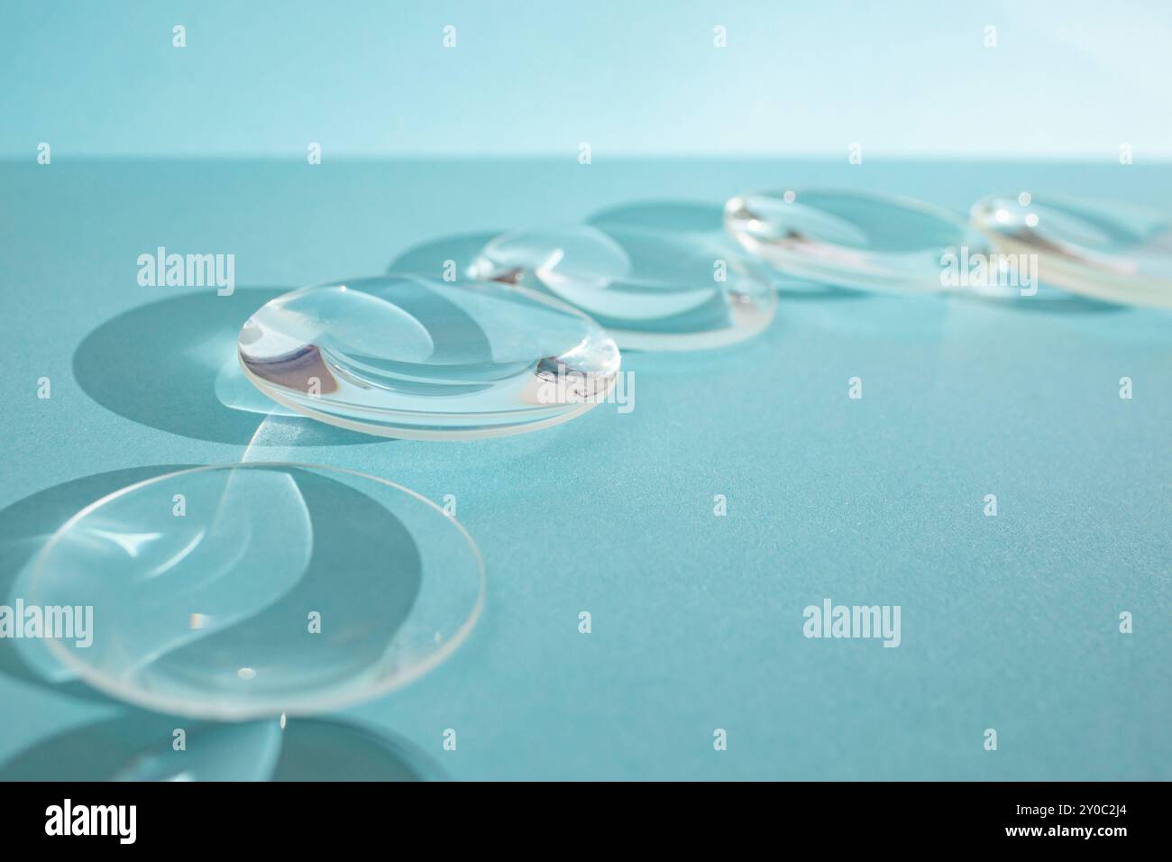 Magnifying lenses in arch shape side view close up on blue background ...