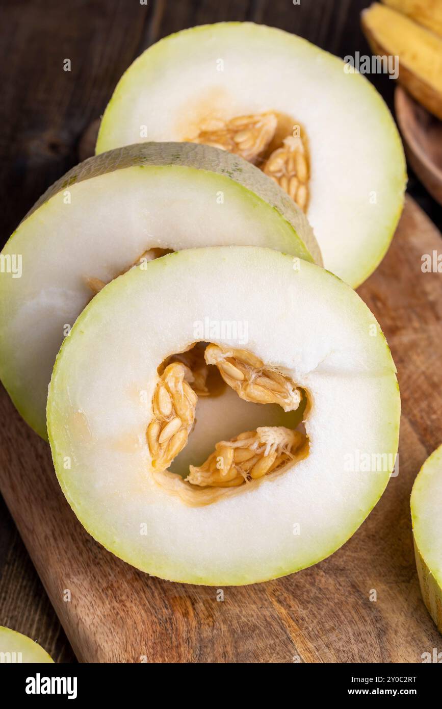 Cut into pieces ripe yellow melon with sweet pulp, cut melon on kitchen ...