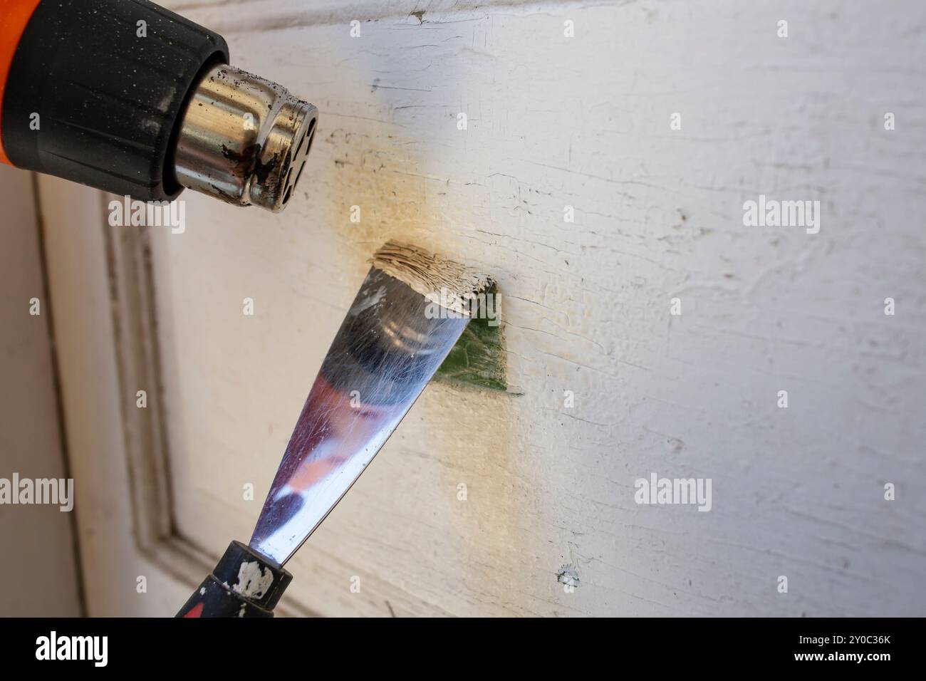 Old paint remove with a heat gun and a scraper, vintage door pannel ...